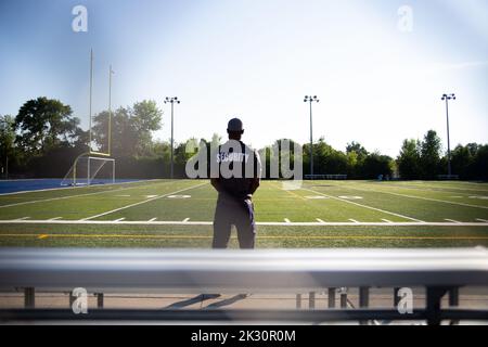 Security guard patrolling soccer stadium Stock Photo - Alamy
