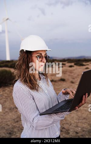 Caucasian female engineer using laptop in computer server room Stock ...