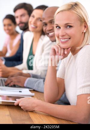 Portrait of smiling multiracial businessmen and businesswomen in board ...