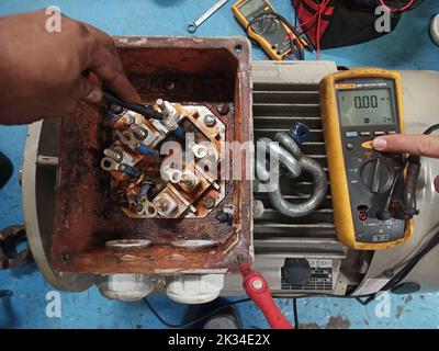 checking insulation of windings of a grounded motor with megger tester ...