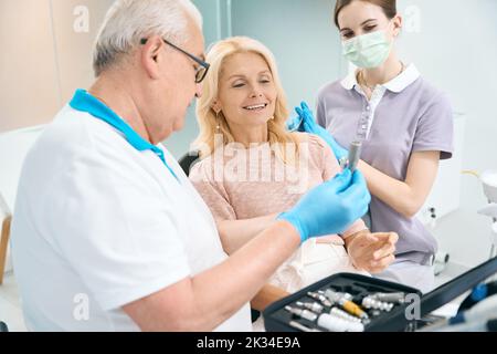 Woman discussing dental bleaching with her dentist Stock Photo - Alamy
