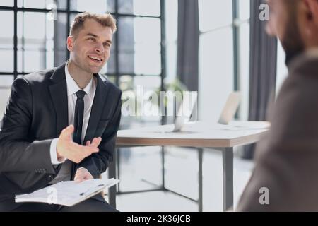 Manager interviewing a candidate in modern office Stock Photo - Alamy