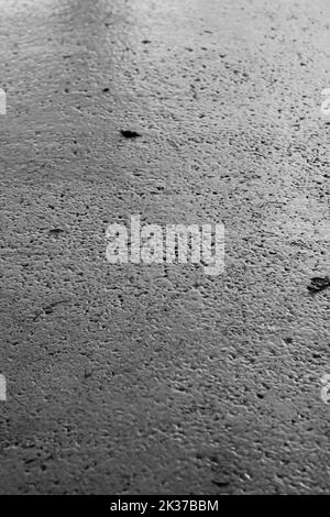 Painted concrete surface with pockmarks in a black and white monochrome ...