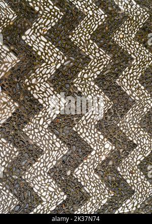 A black and white wavy pebble floor design on the island in Greece ...