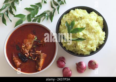 Mashed tapioca served with pomfret fish curry. Boiled and strained ...