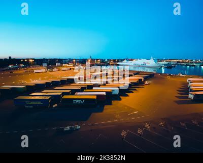 A bunch of parked lorry or truck trailers in front of a ferry boat in ...
