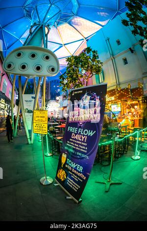 Street view of lighted Clarke Quay in historic riverside quay, famous ...