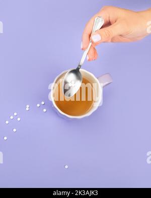 Tea cup with suagr substitute on color background. The concept of ...