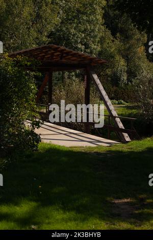 Image of a wooden foot bridge crossing a river in a forest Stock Photo ...
