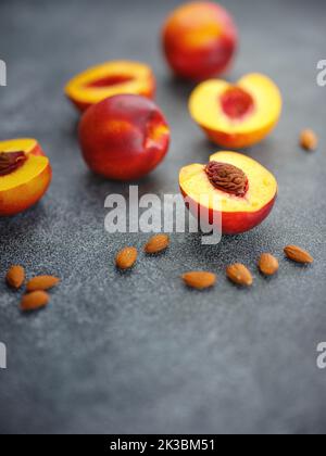 Sliced nectarine on dark wooden cutting board Stock Photo - Alamy