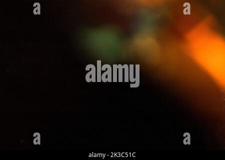 colorful warm rainbow light leaks on black background with dust texture ...