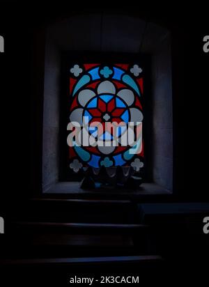 Dimly lit stained glass window of a church Stock Photo - Alamy