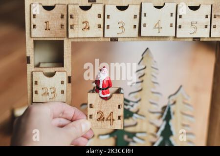 Hand opens wooden advent calendar Stock Photo - Alamy