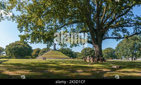 Black crosses of graves under trees at German Military Cemetery and ...
