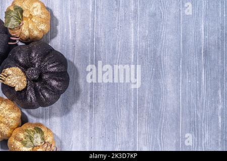 Black and cold colored pumpkins on gray wooden background. Minimalist ...