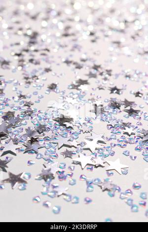 Shimmer stars and blue crystals confetti on a silver background. Shiny ...