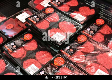 Cora supermarket: butcher's counter, shrink-wrapped carton, red meat ...