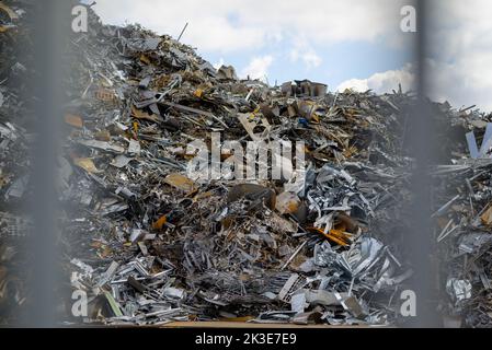 Scrap dealer with a huge mountain of old steel and scrap Stock Photo ...
