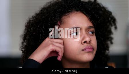 Black little girl thinking pondering problem solving. Thoughtful child ...