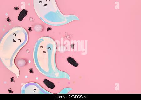 Cute pastel colored Halloween party flat lay with ghost shaped plates ...