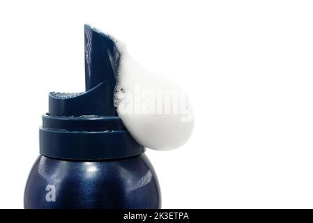 Shaving foam is squeezed out of a balloon on a white background. Lather ...
