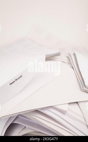 sheets of plain white paper stapled at the corner and folded over lying ...