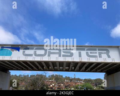 Coaster sign of a commuter rail service on rail the road bridge. - San ...