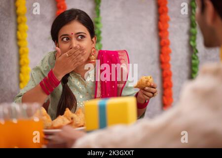 Woman eating samosa the traditional Indian snack Stock Photo - Alamy