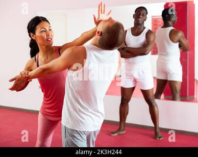 Active woman and her trainer are training captures Stock Photo - Alamy