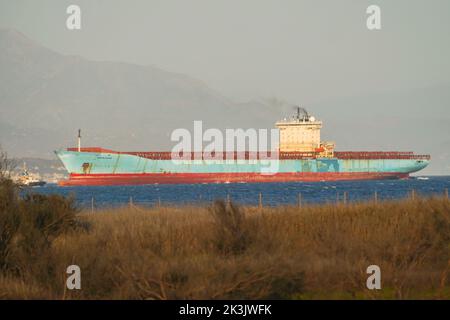 Container ship MAERSK KOTKA, near Malaga, with Guadalhorce natural park ...