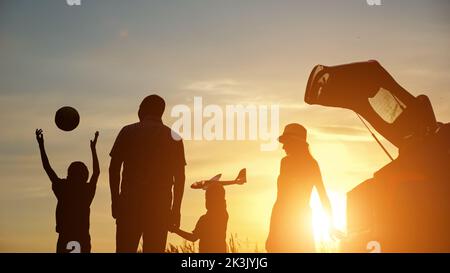 Family standing near car spends time together at back sunset Stock ...