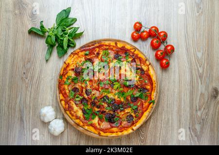 Sausage, greens, tomato on plate on wooden table Stock Photo - Alamy