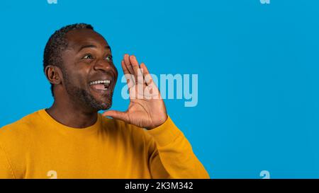 Happy black man yelling towards copy space, full length Stock Photo - Alamy