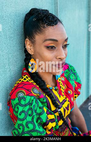Trendy ethnic female in sandals reading textbook while sitting with ...