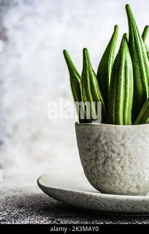 Bowls of bamia vegetable on concrete background Stock Photo - Alamy