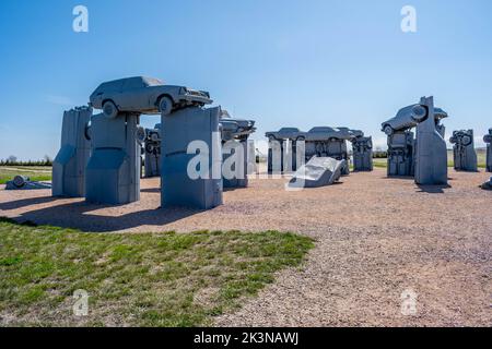A piled up vintage automobiles all covered with gray spray paint in ...
