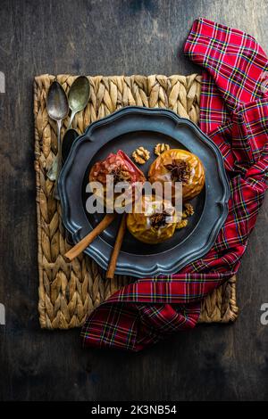 Baked apples with honey and walnuts served with spices Stock Photo - Alamy