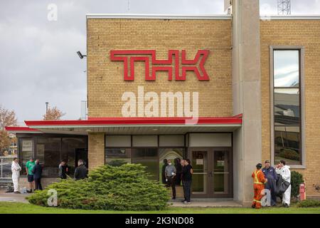 Employees of THK Rhythm Automotive plant wait outside of the St ...