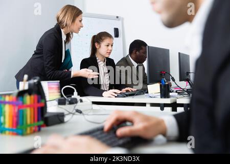Portrait of team of buisness people working with laptops in office ...