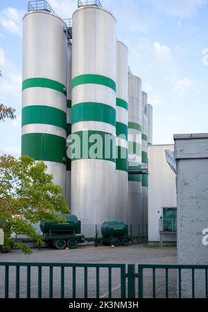 The building of the Eichbaum brewery with silos and flags produces a ...