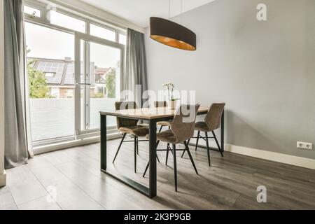 Couch and armchairs placed around table with decorations in dining area ...