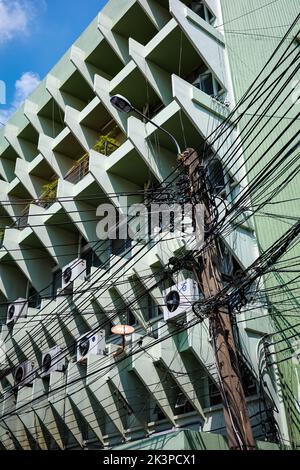 Intertwined electric wires in front of buildings which is the first ...
