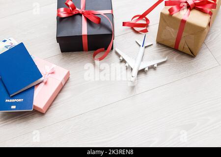 Christmas airplane travel concept. Passports, toy white plane. Gift box ...