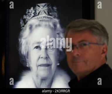 Rob Munday poses next to a piece by Munday in collaboration with Chris ...