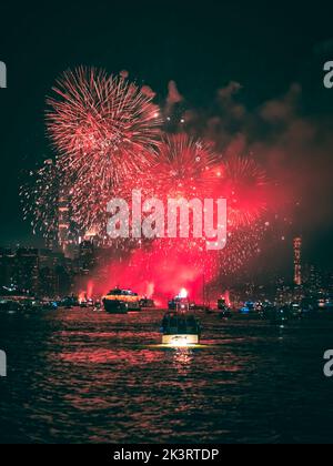 A vertical shot of exploding red fireworks in the sky at night Stock ...