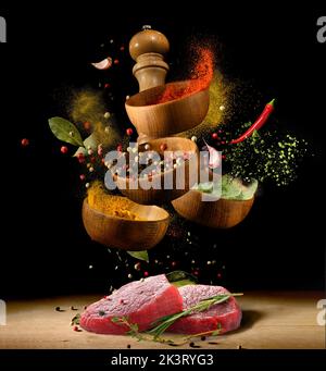 Raw beef steaks, with herbs, on wooden table. Concept of food cooking ...
