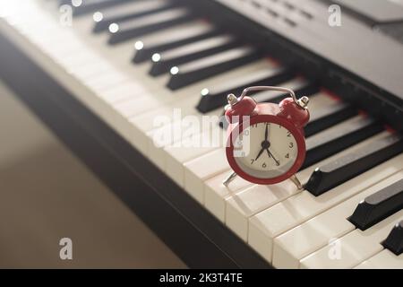 alarm clock on piano, synthesizer Stock Photo - Alamy