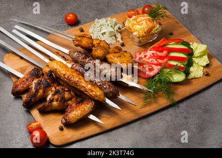 tasty assorted lula kebab: pork, lamb, chicken on a wooden board Stock ...