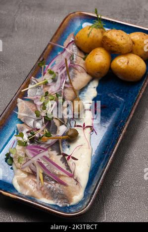 Salted herring marinated fillet with skin Stock Photo - Alamy