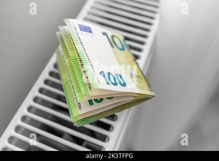 Euro banknotes on a heated radiator Stock Photo - Alamy